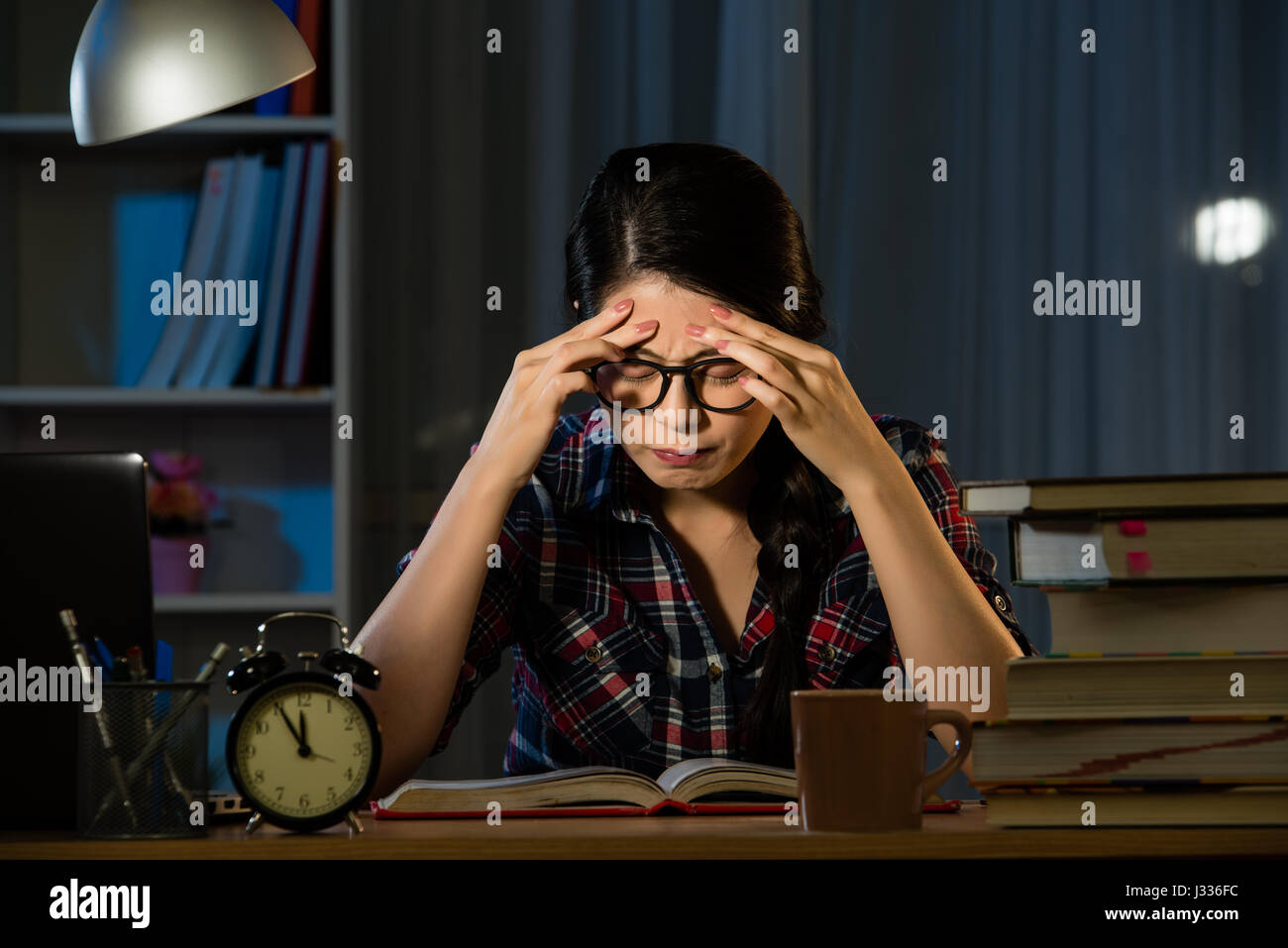 Female student studying and using pc at home getting headache. Tired ...