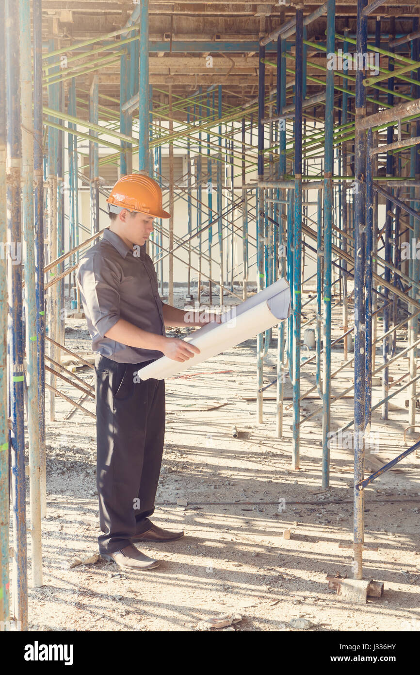 Construction concepts, Engineer and Architect working at Construction Site with blueprint ...