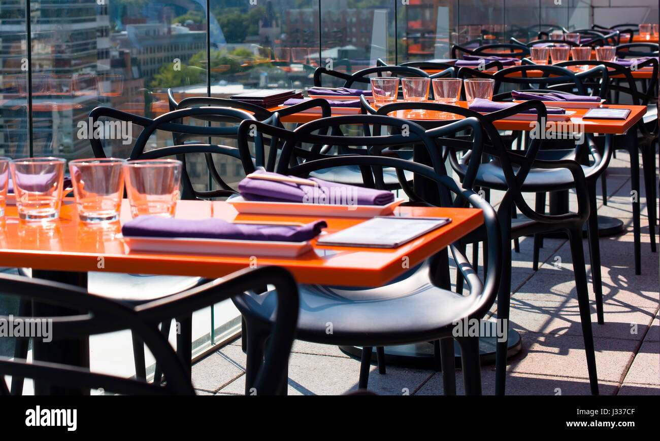 Interior of a modern restaurant with modern orange rectangular tables ...