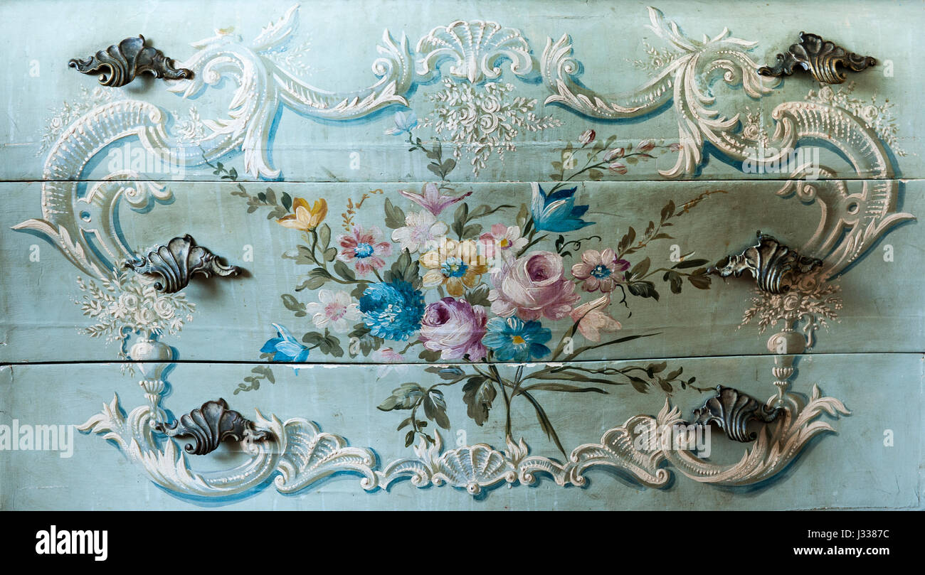Detail of drawer carving with flowers and handles Stock Photo - Alamy
