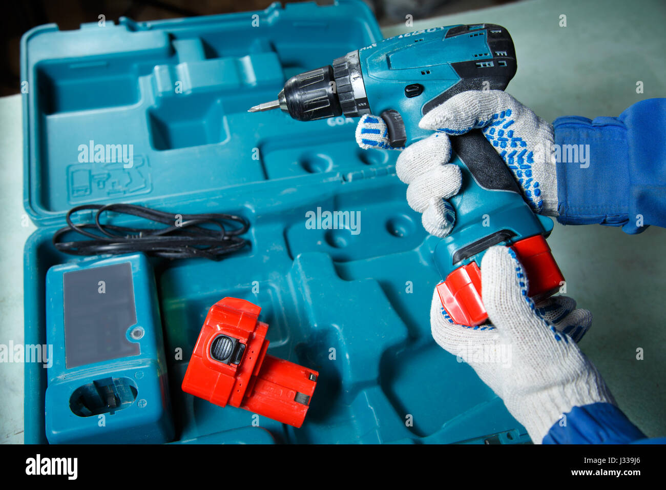 Male hand holding a screwdriver in closeup Stock Photo - Alamy