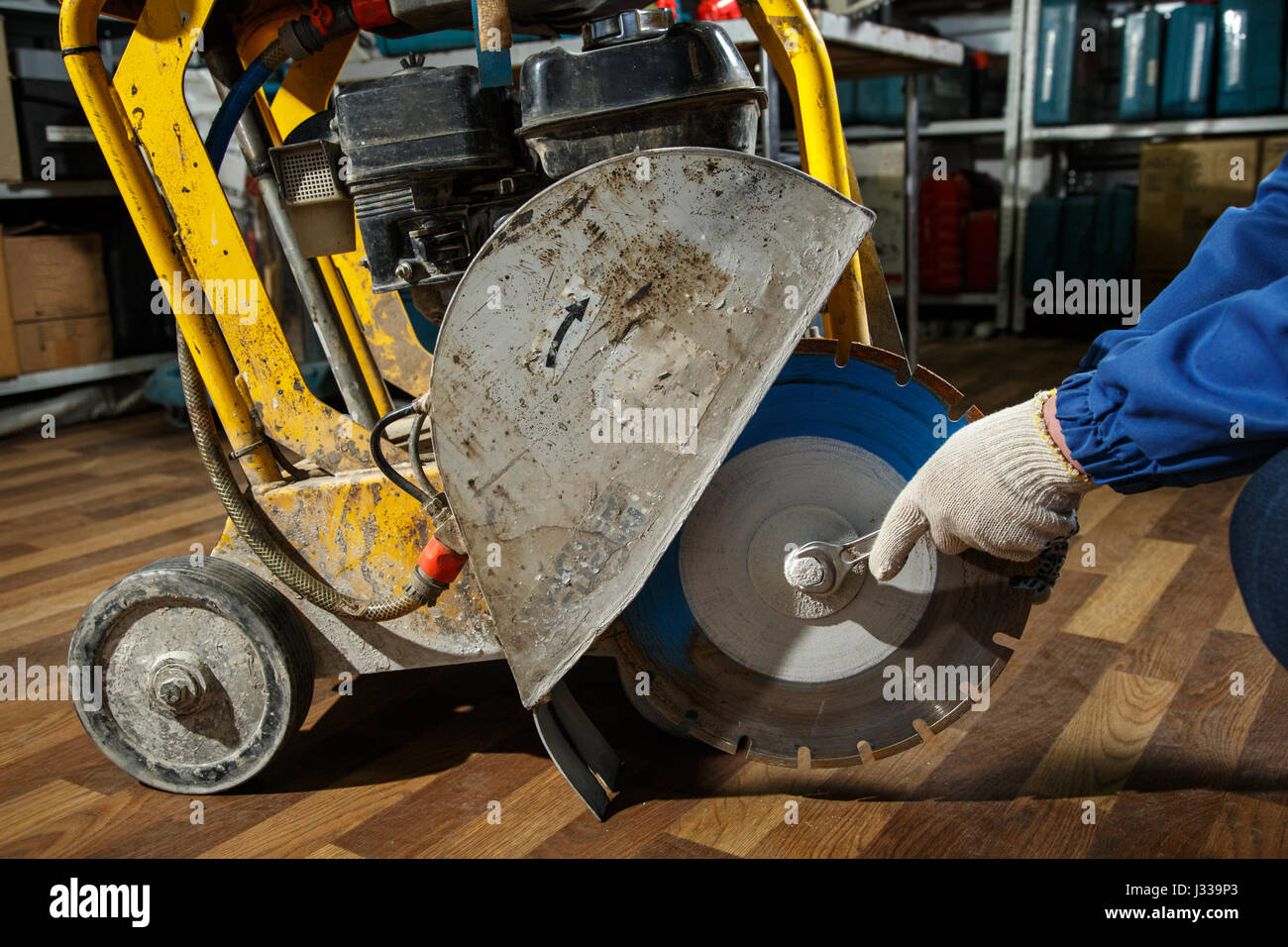 Replace a saw in a floor cutting saw in closeup Stock Photo - Alamy