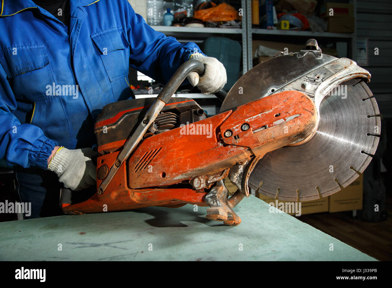 Floor cutting saw in man's hands in closeup Stock Photo - Alamy