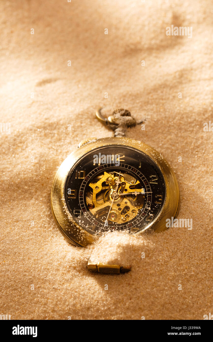 Pocket watch in beach sand light closeup Stock Photo - Alamy