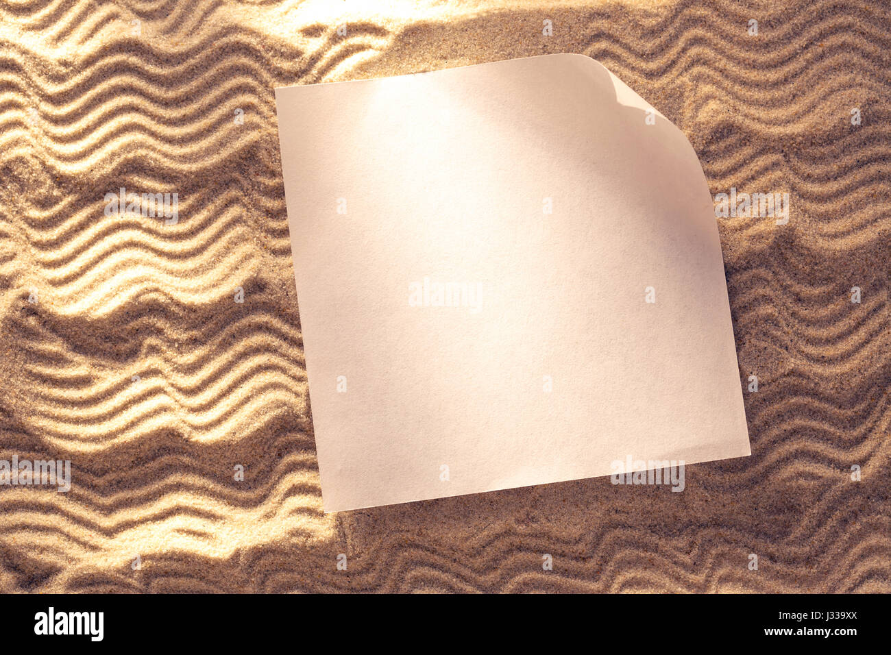 Blank sheet of paper on sand background Stock Photo - Alamy