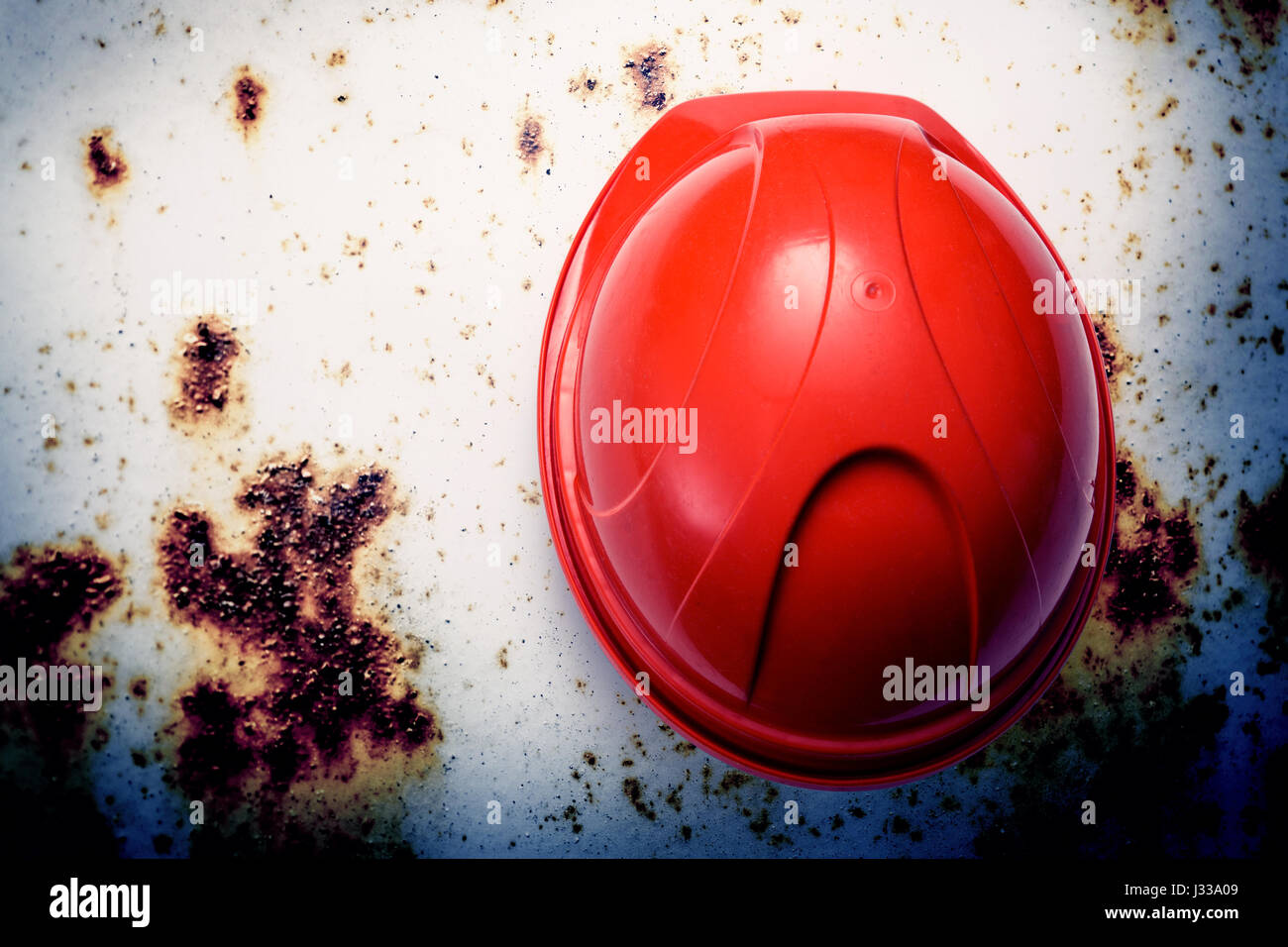 Red safety helmet from the top on metal background Stock Photo - Alamy