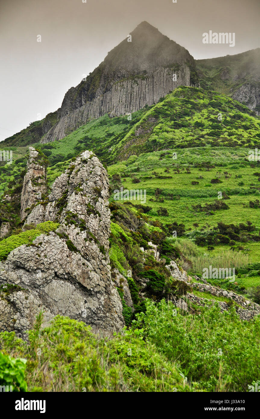 Volcanic basalt mountain Rocha dos Bordoes in the foggy highlands ...