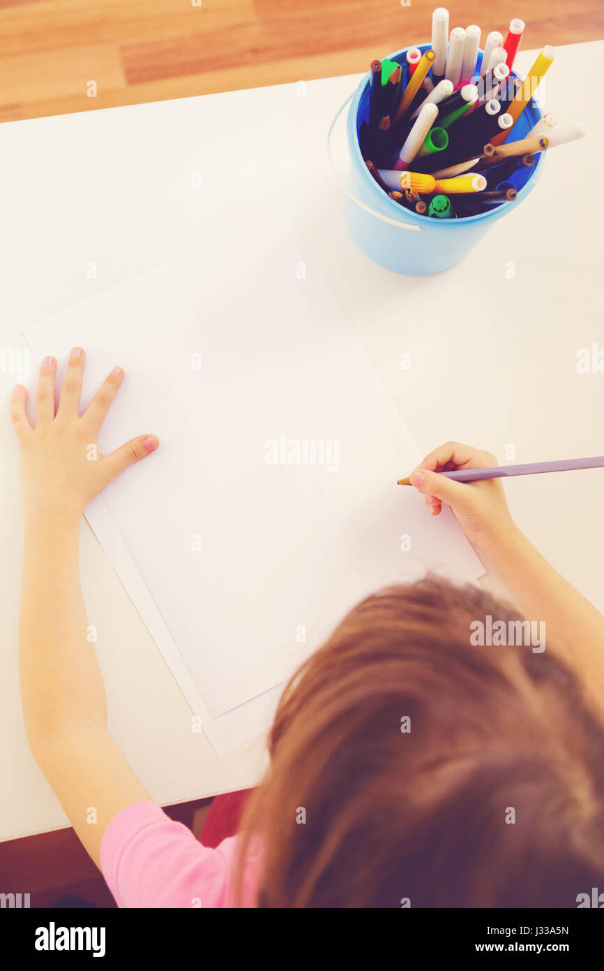 Child's hands with pencil view from above Stock Photo - Alamy
