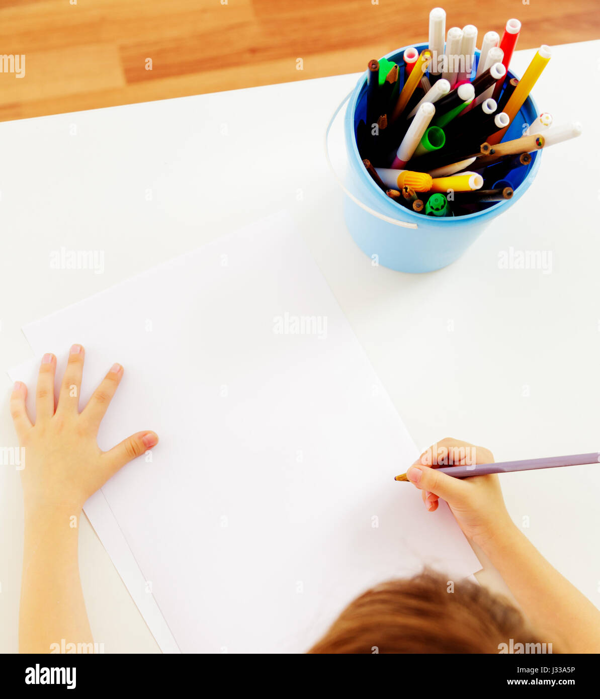 Child's hands with pencil view from above Stock Photo - Alamy