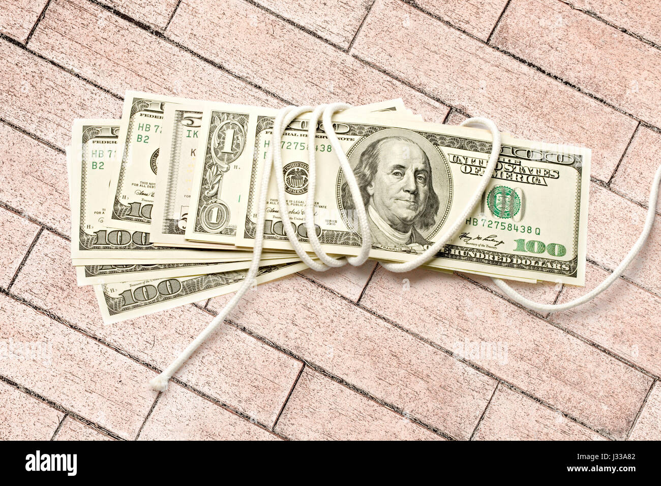 Dollar banknotes wrapped with white rope closeup Stock Photo - Alamy