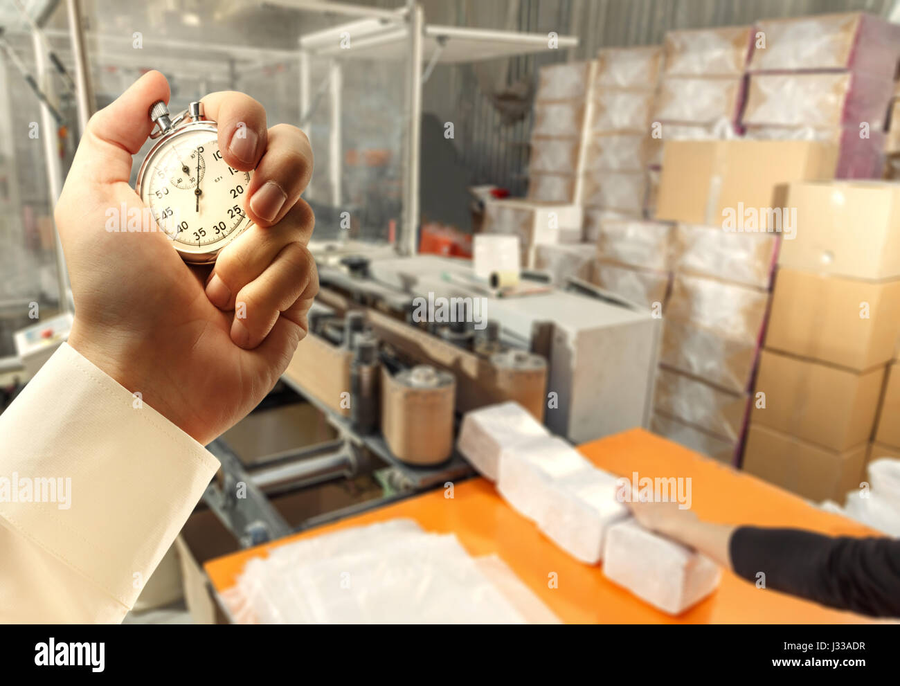 Process of paper products manufacturing and stopwatch in male hand ...