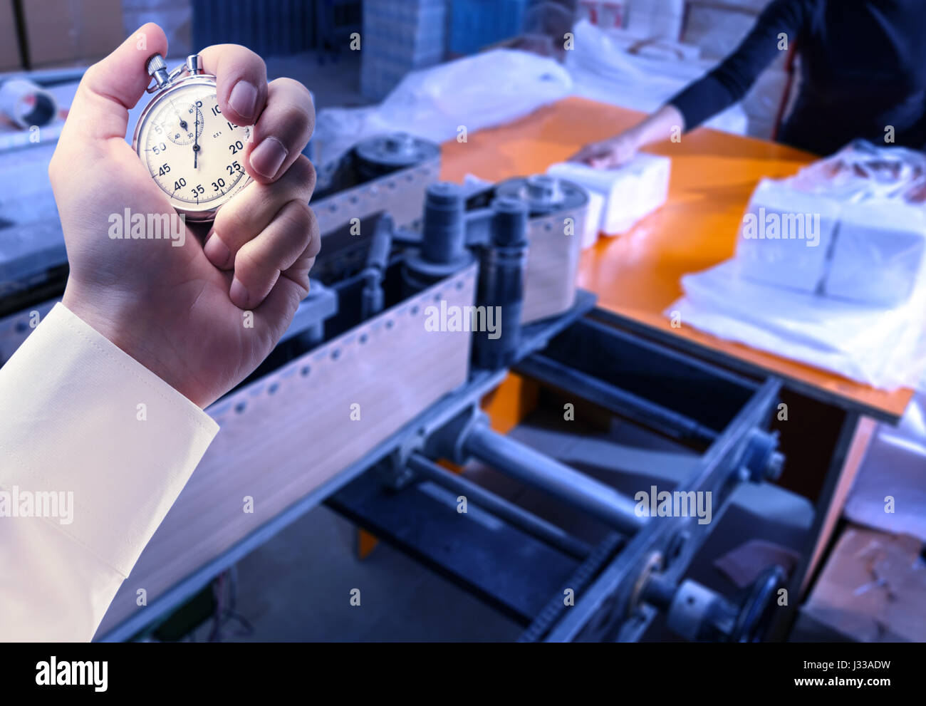 Process of paper products manufacturing and stopwatch in male hand ...