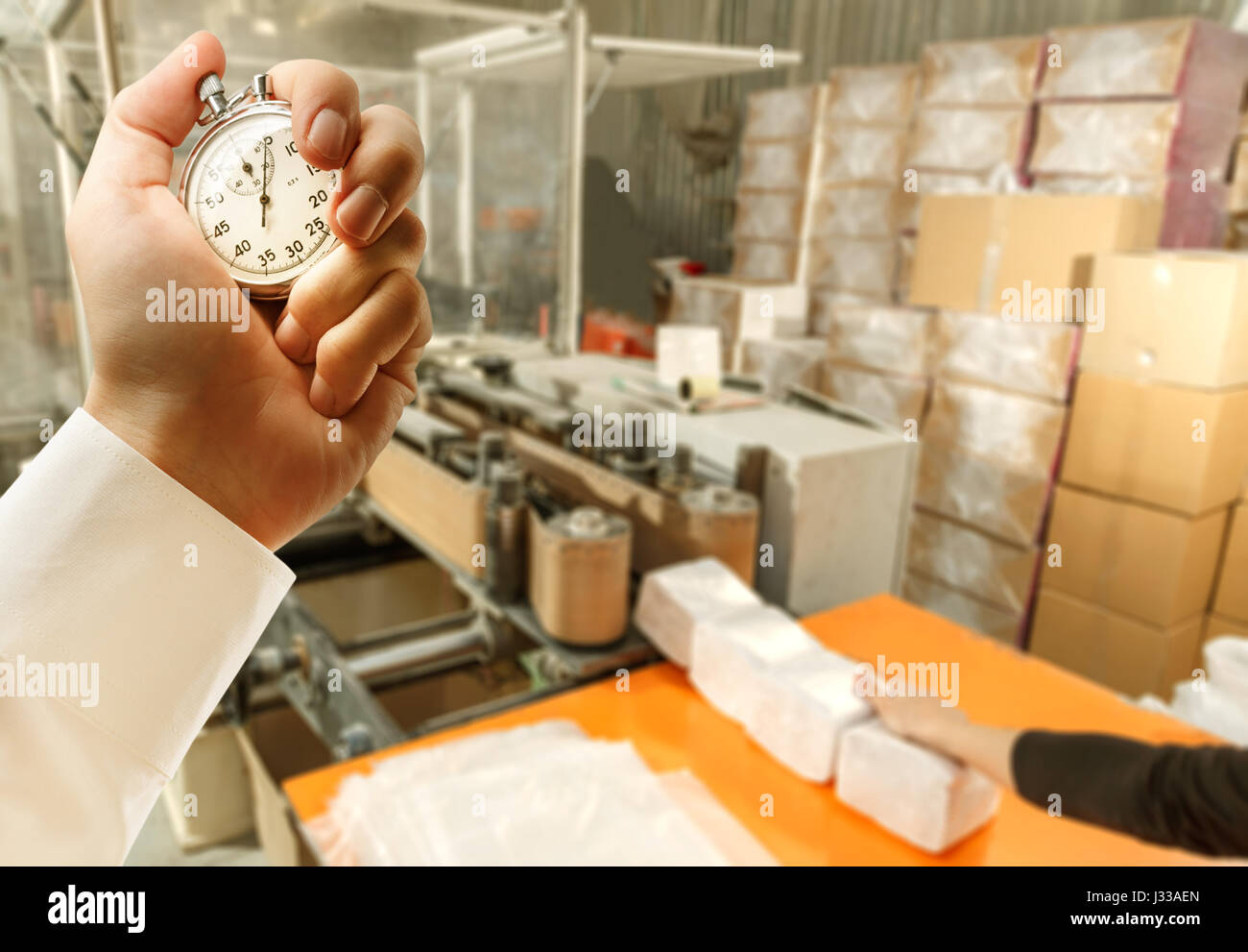 Process of paper products manufacturing and stopwatch in male hand ...