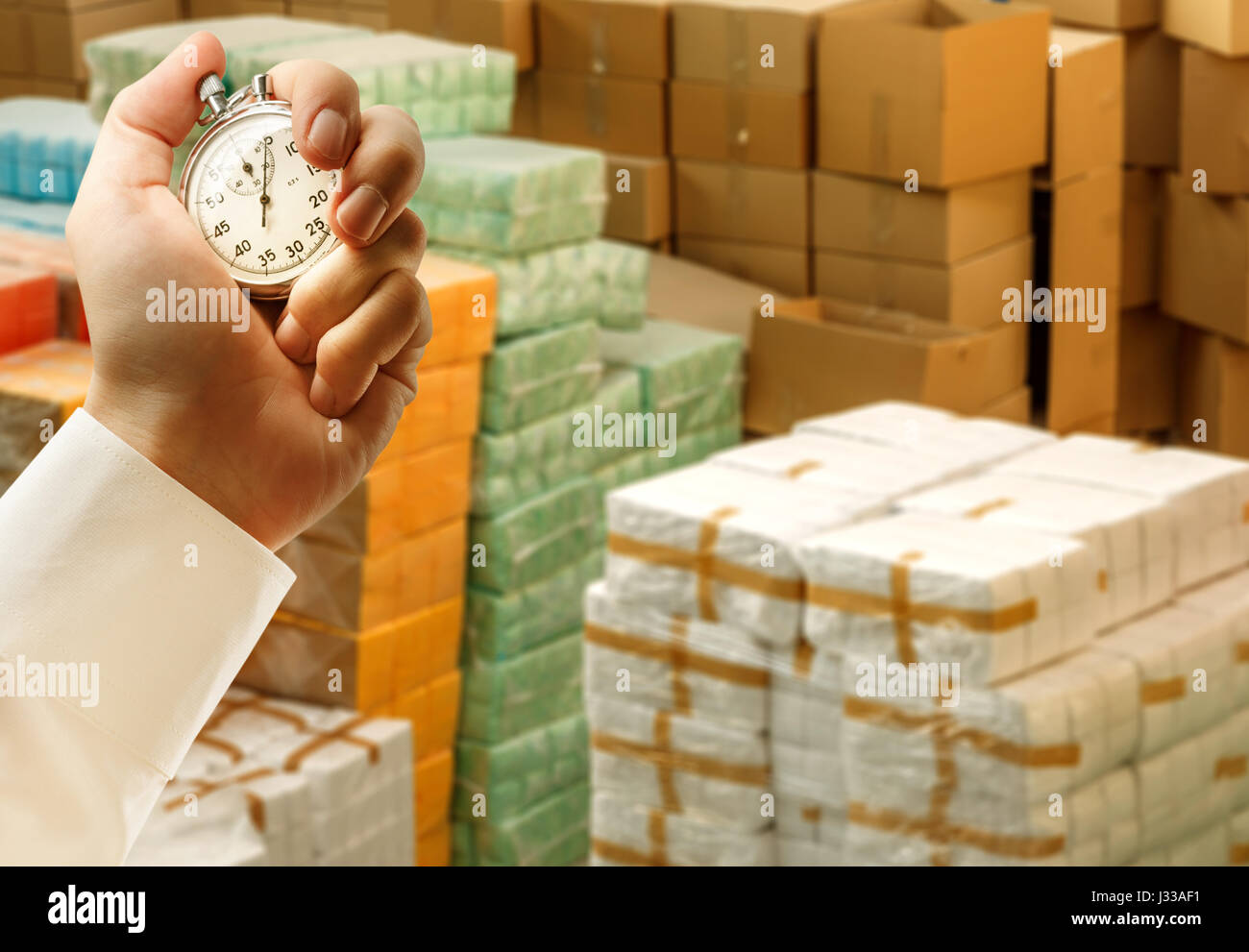 Paper products storehouse and stopwatch in male hand Stock Photo - Alamy