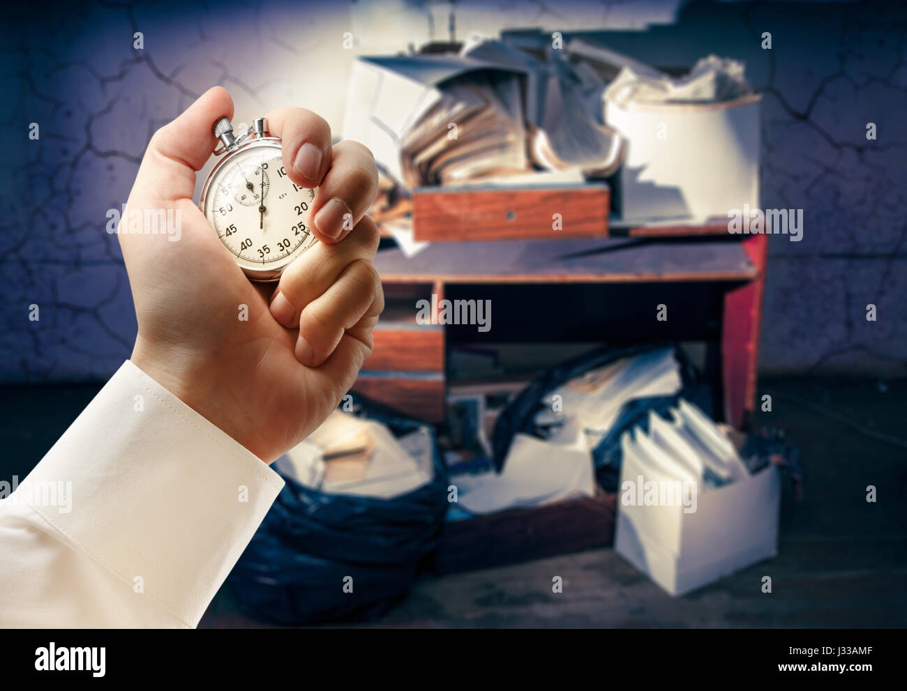 Messy workplace and stopwatch in male hand Stock Photo - Alamy