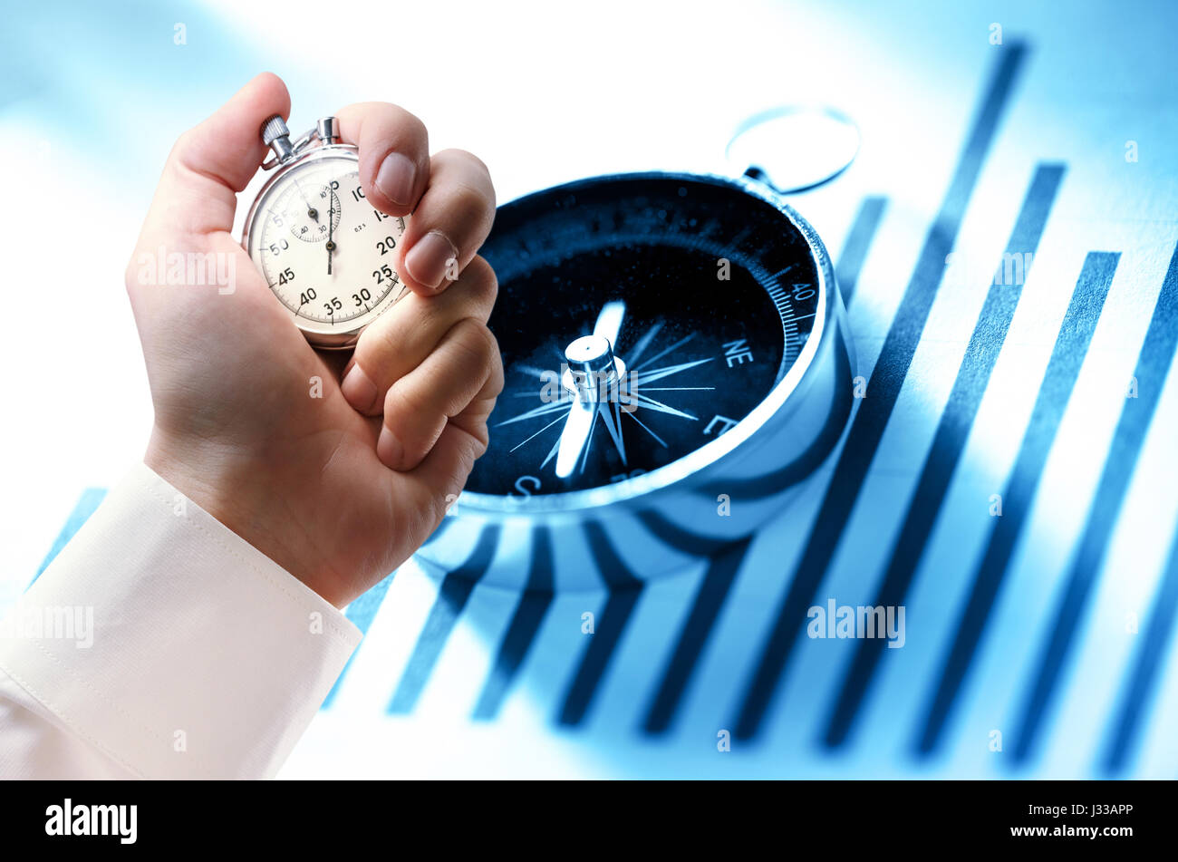 Diagram concept with compass and stopwatch in male hand Stock Photo - Alamy
