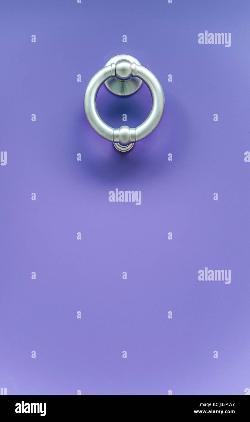 A metal door knocker on a purple door Stock Photo - Alamy