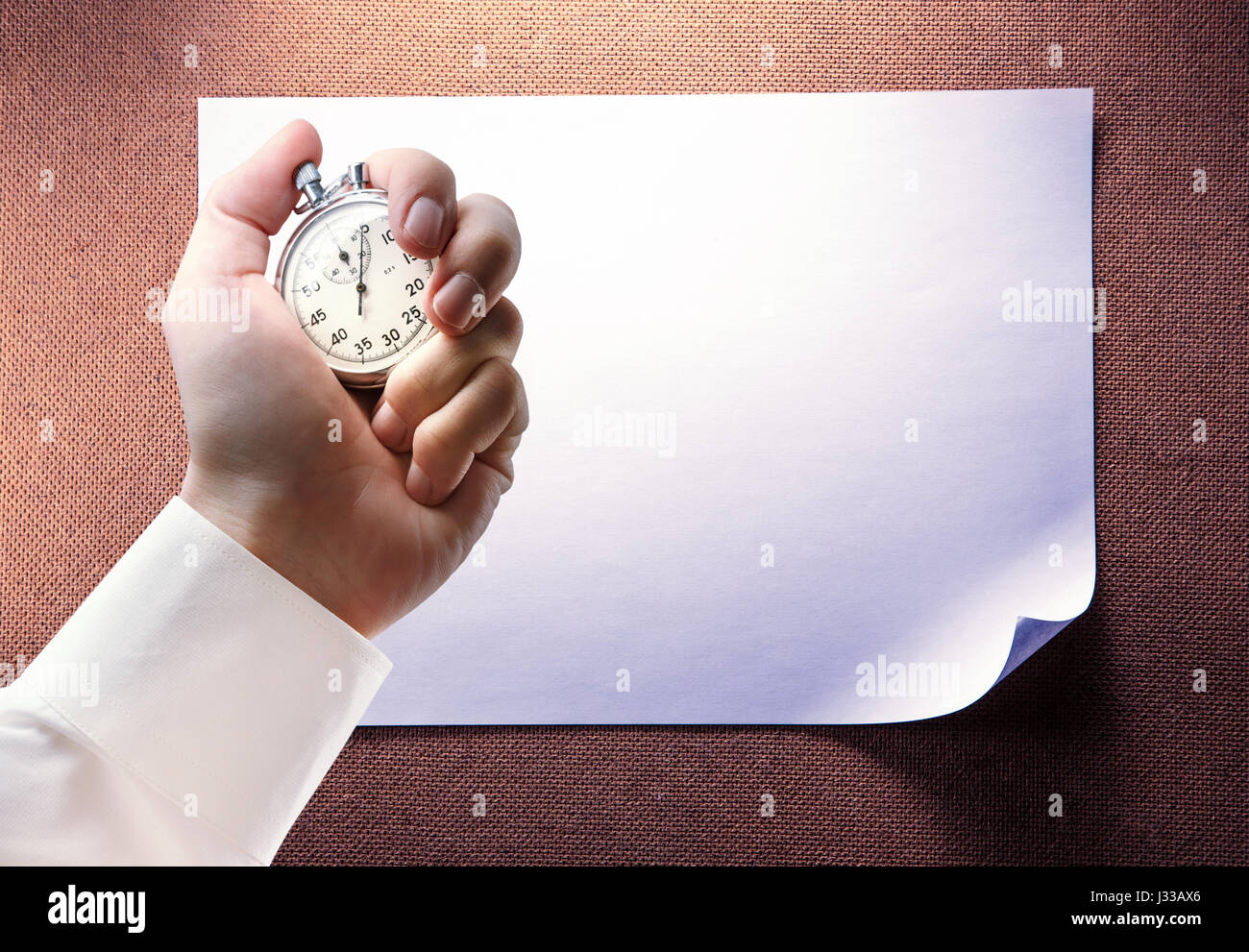 Blank sheet of paper and stopwatch in male hand Stock Photo - Alamy
