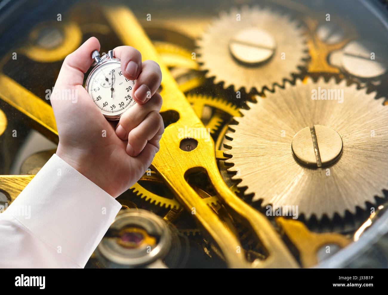 Clockwork inside mechanism and stopwatch in male hand Stock Photo - Alamy