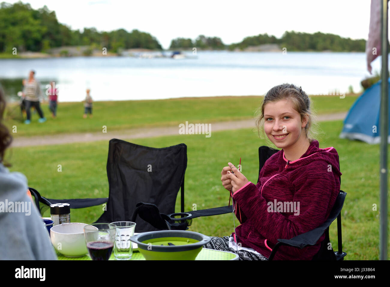 Girl knitting outside, camping ground, Vaestervik, Smaland, Sweden ...