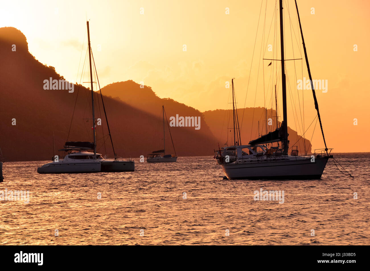 sailing ships at sunset anchoring at Bequia island, sea, St. Vincent ...