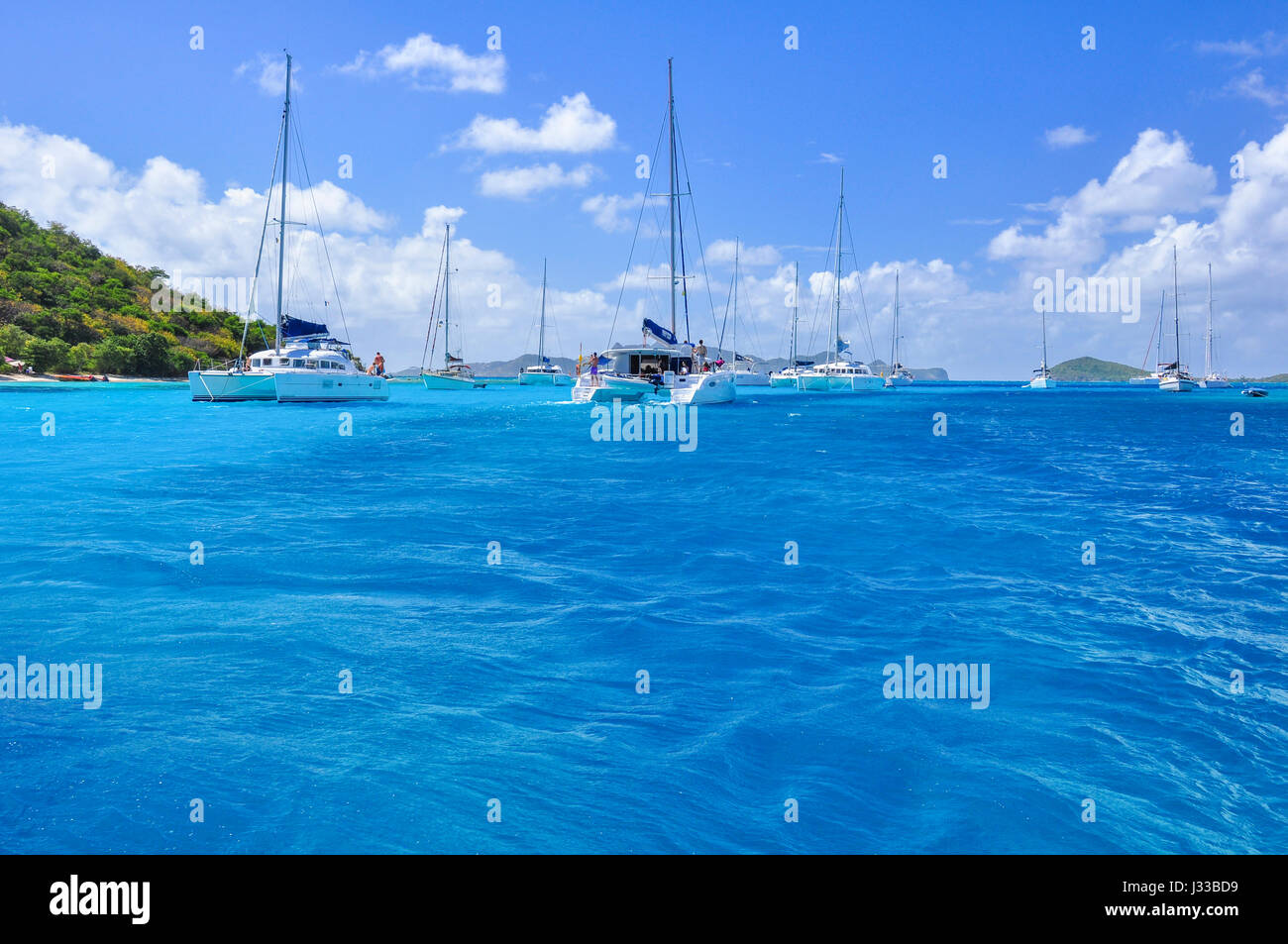 sailing ships on the sea in front of Petit Rameau island, Tobago Cays ...