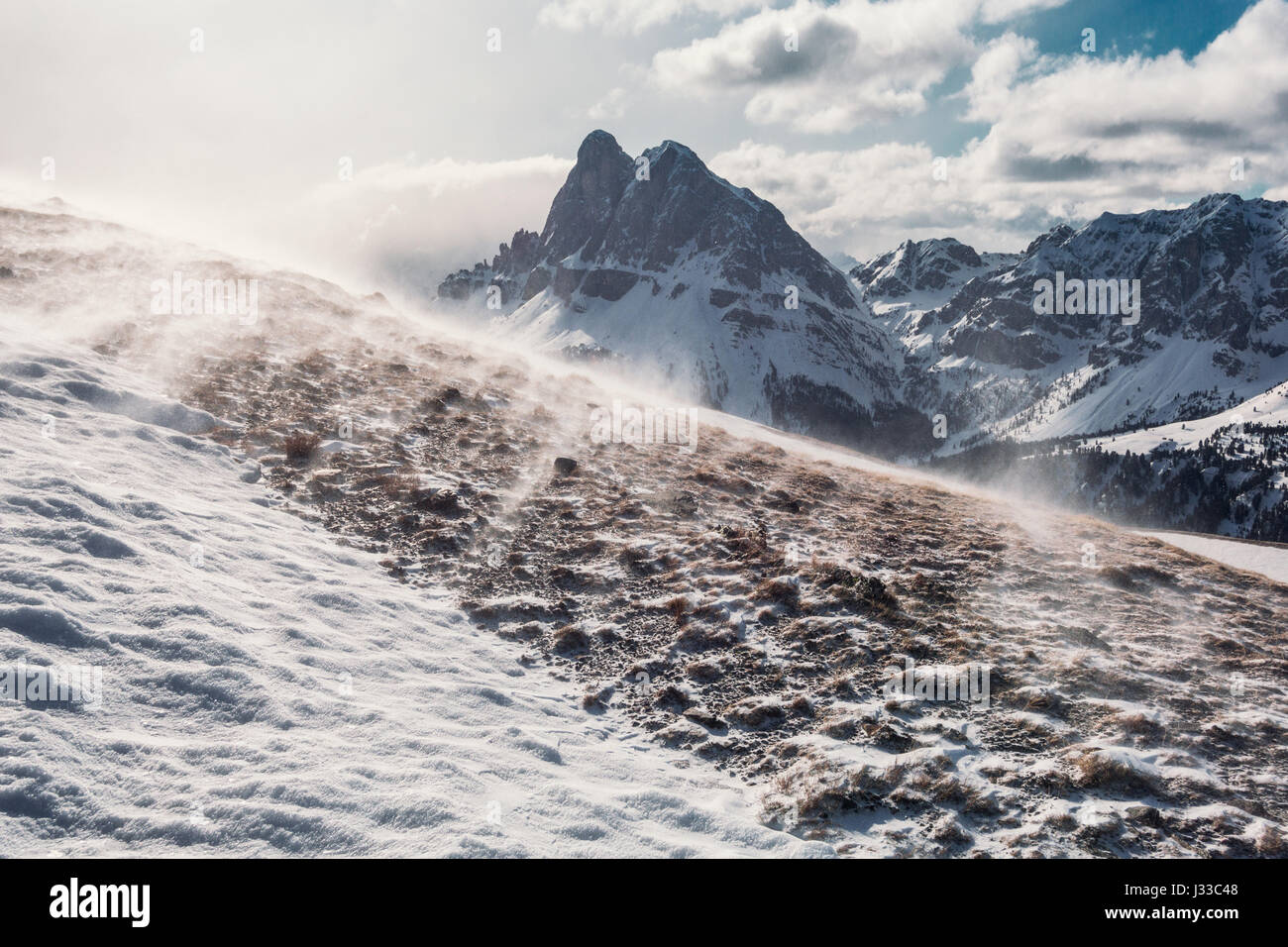 Snow blowing on top of the Gabler mountain,the Peitlerkofel in the ...