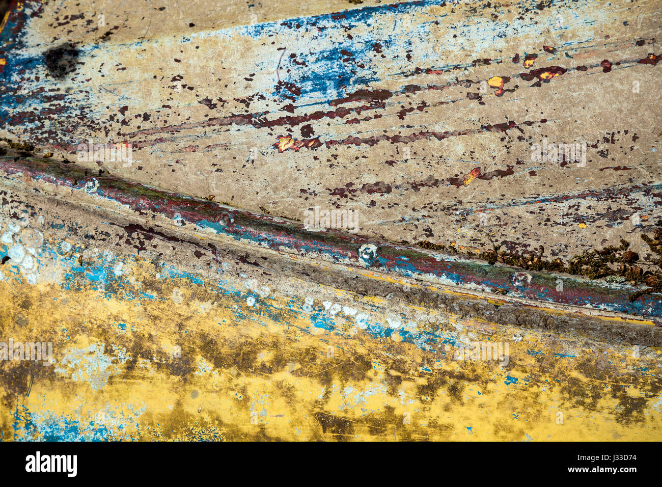 Coloured texture on ribbed hull of upturned boat showing abstract ...