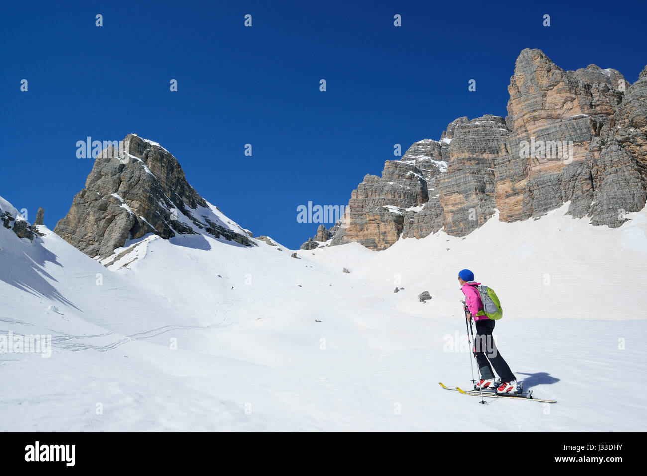 Female back-country skier ascending to Corno d Angolo, Cristallo Group ...