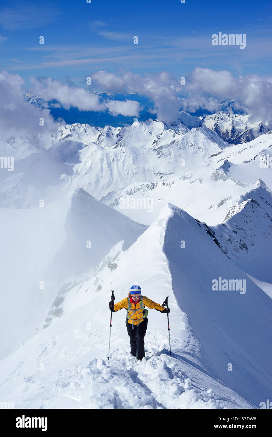 Female back-country skier ascending to Grosser Moeseler, Zillertal Alps ...