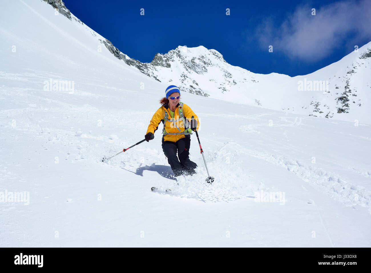Female back-country skier downhill skiing from Grosser Moeseler ...