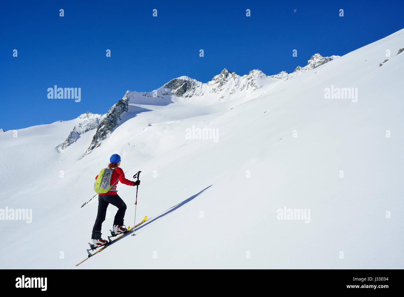 Female back-country skier ascending to Schlieferspitze, Venediger Group ...