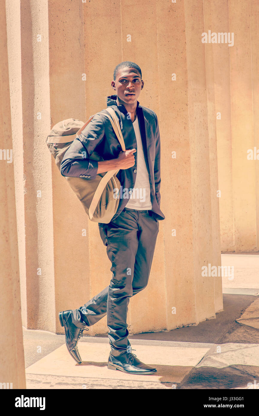 Young African American Man traveling in New York, carrying shoulder bag ...