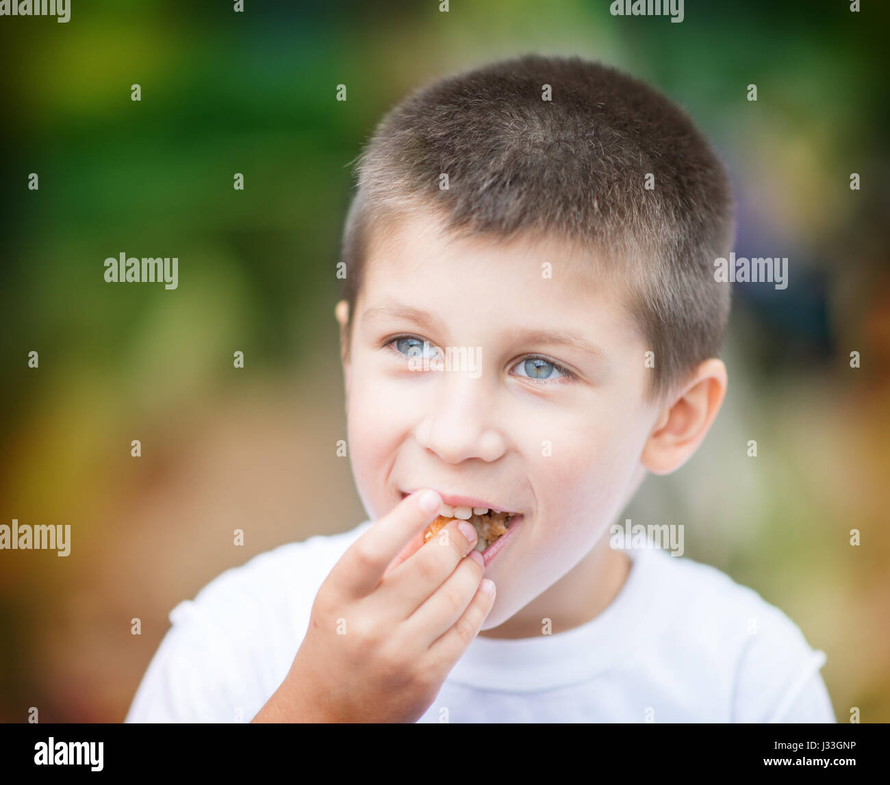 Beautiful boy eating a healthy food outdoor Stock Photo - Alamy