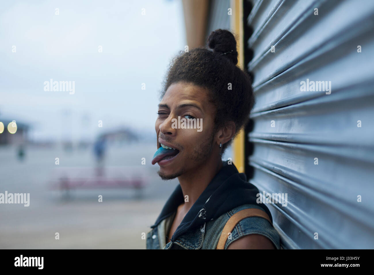 Young man sticking out his blue tongue Stock Photo - Alamy