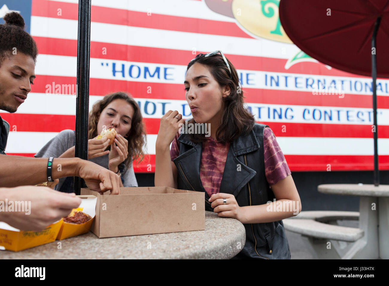 Friends enjoying fast food Stock Photo - Alamy