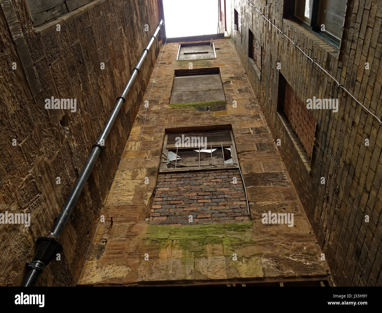Glasgow alley it backstreet bars on windows dilapidated doors and ...