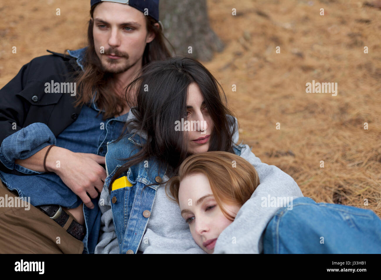 Friends hanging out in a forest Stock Photo - Alamy