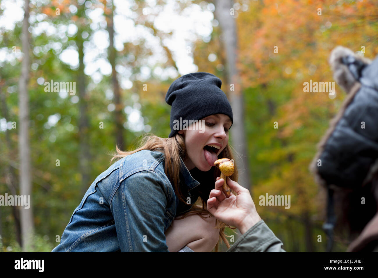Young couple hanging out in the forest Stock Photo - Alamy