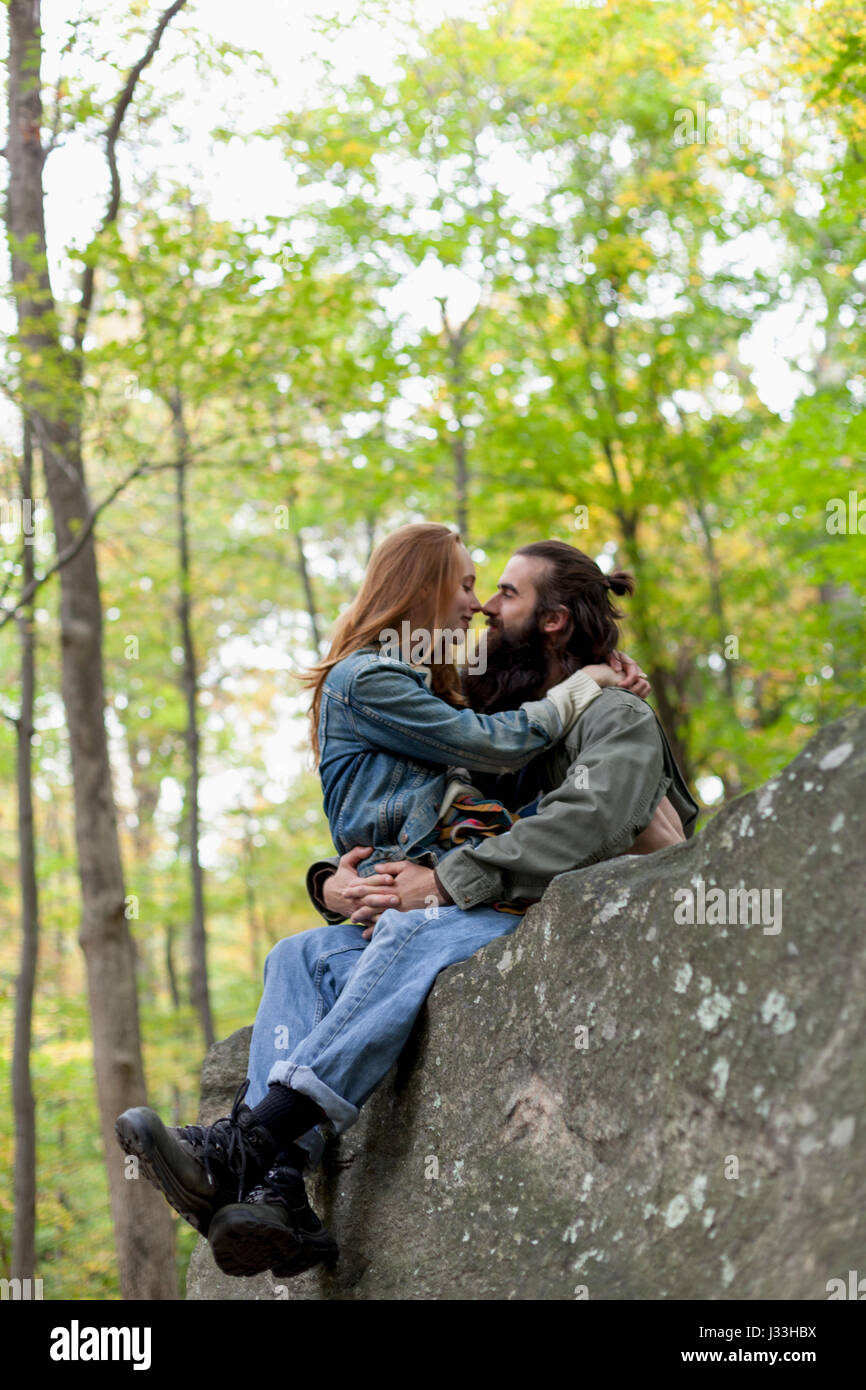 Young couple hanging out in the forest Stock Photo - Alamy