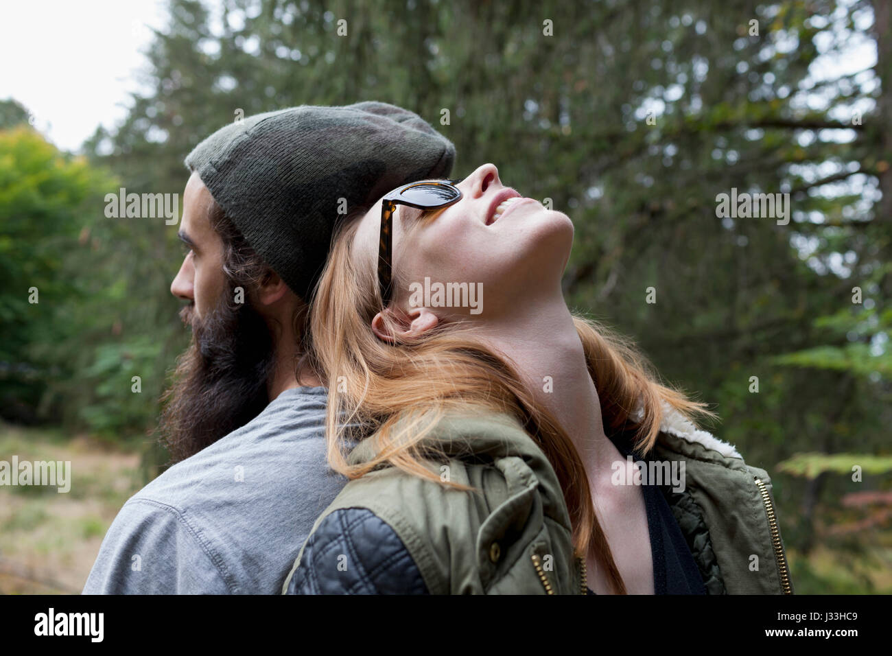Young couple hanging out in the forest Stock Photo - Alamy