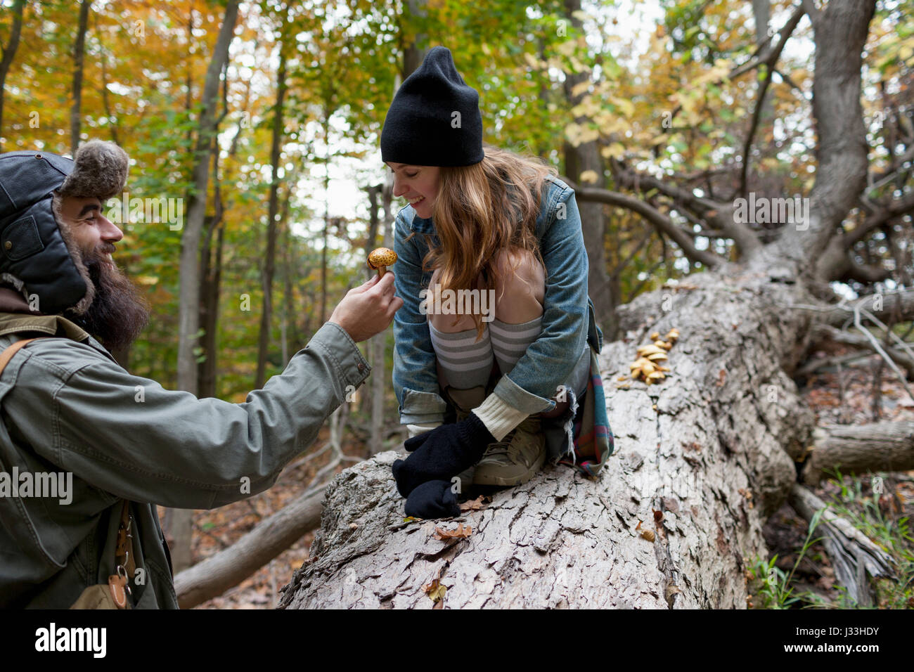 Young couple hanging out in the forest Stock Photo - Alamy