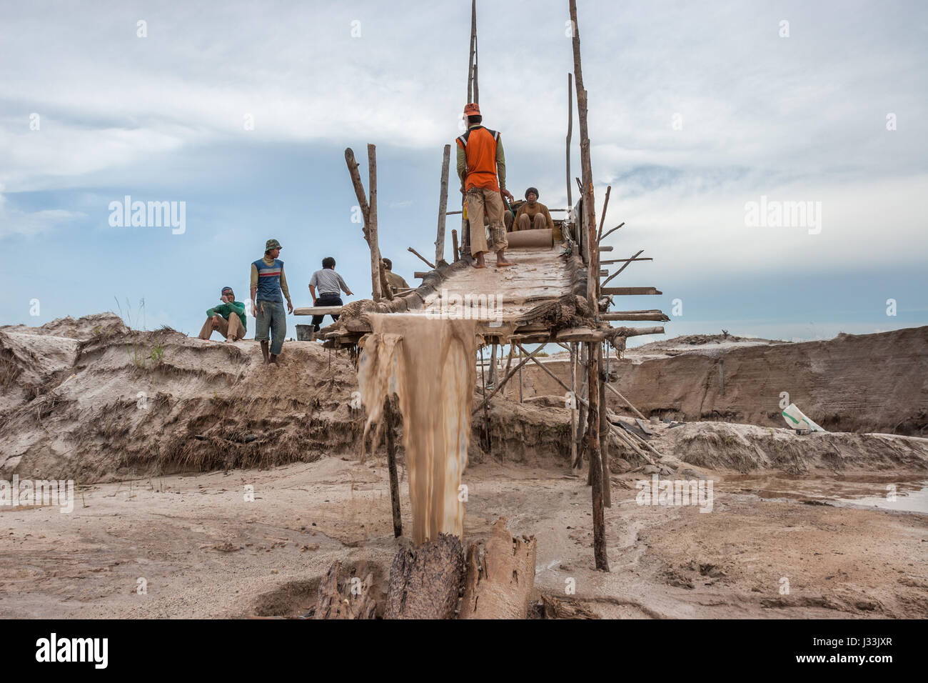 A group of small-scale gold mining with their placer box installation ...