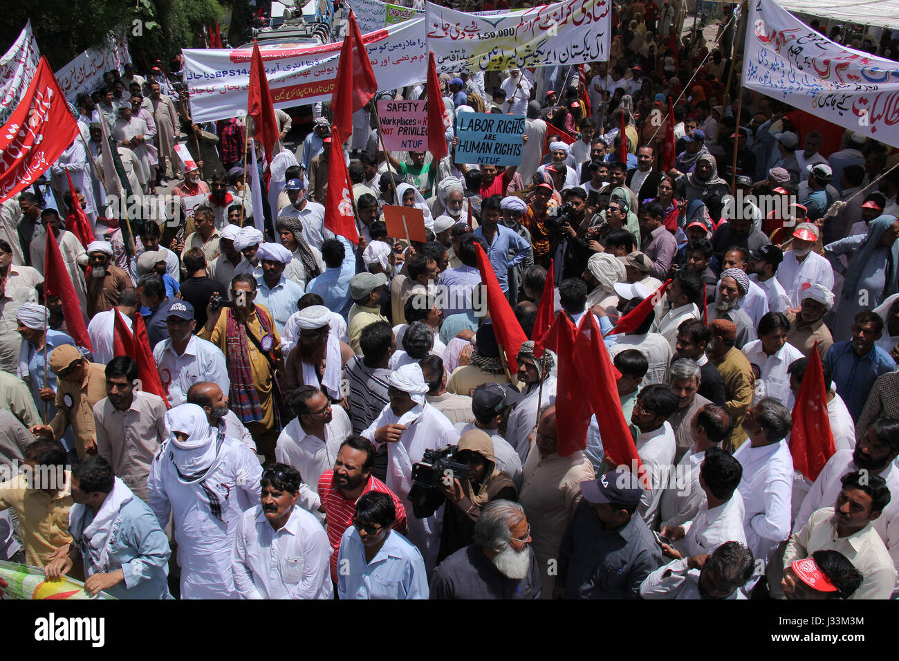 Lahore, Pakistan. 02nd May, 2017. Pakistani workers carry cutouts of ...