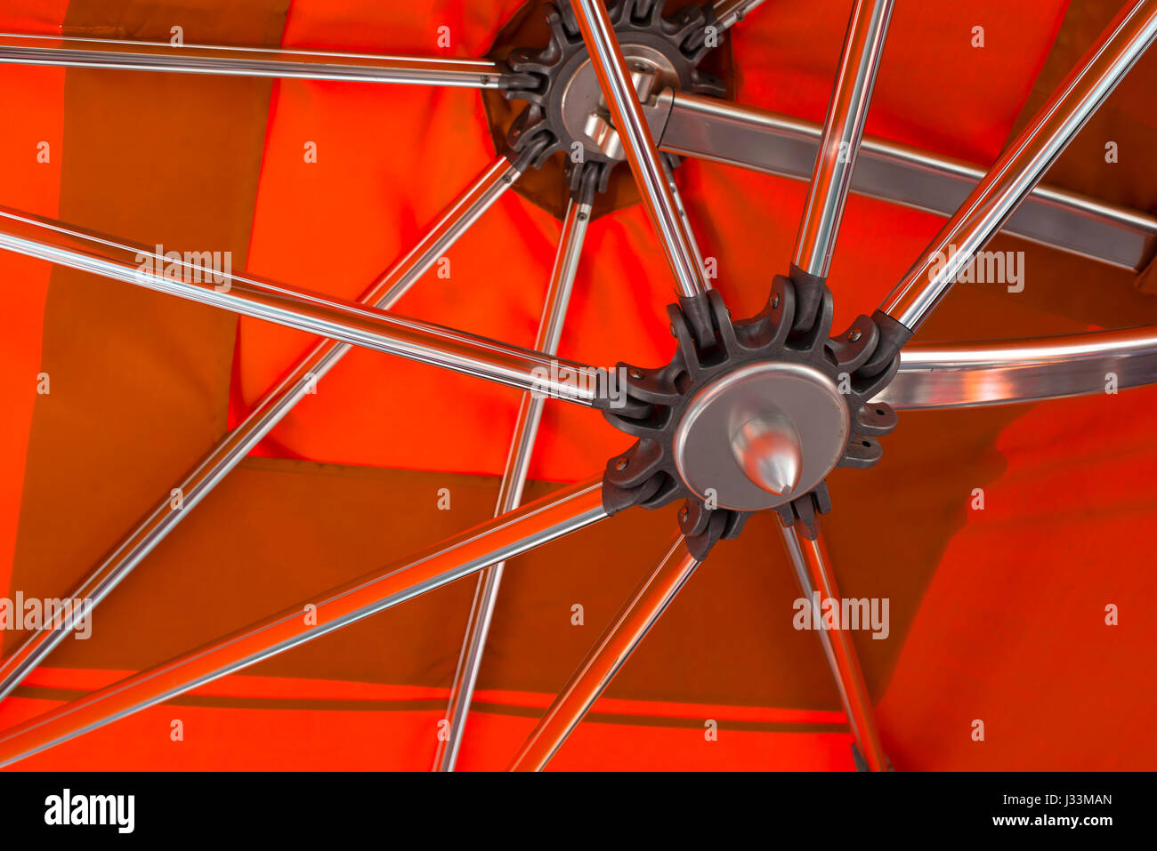 Stainless steel frame umbrella from rain and sun of a bright orange ...