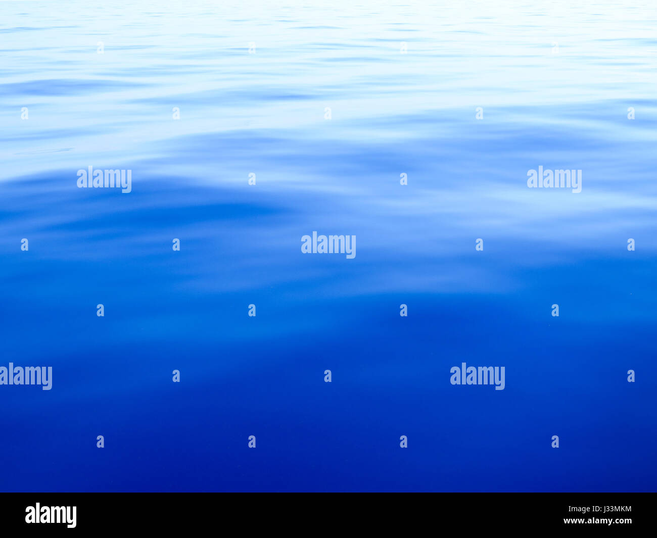 Still blue ocean water surface Stock Photo - Alamy