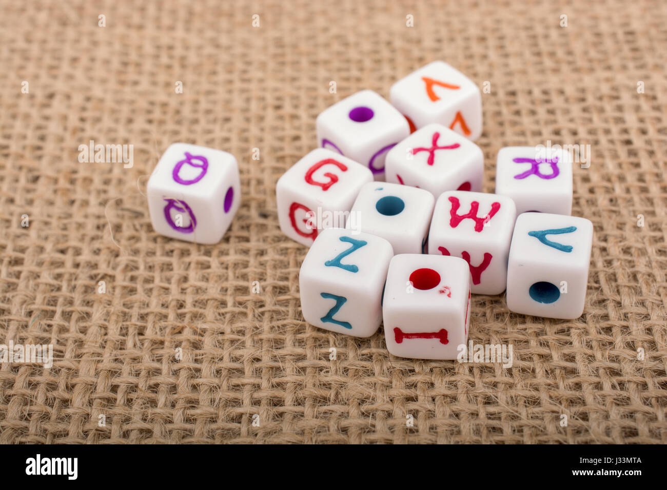 Colorful alphabet letter cubes on a linen canvas Stock Photo - Alamy