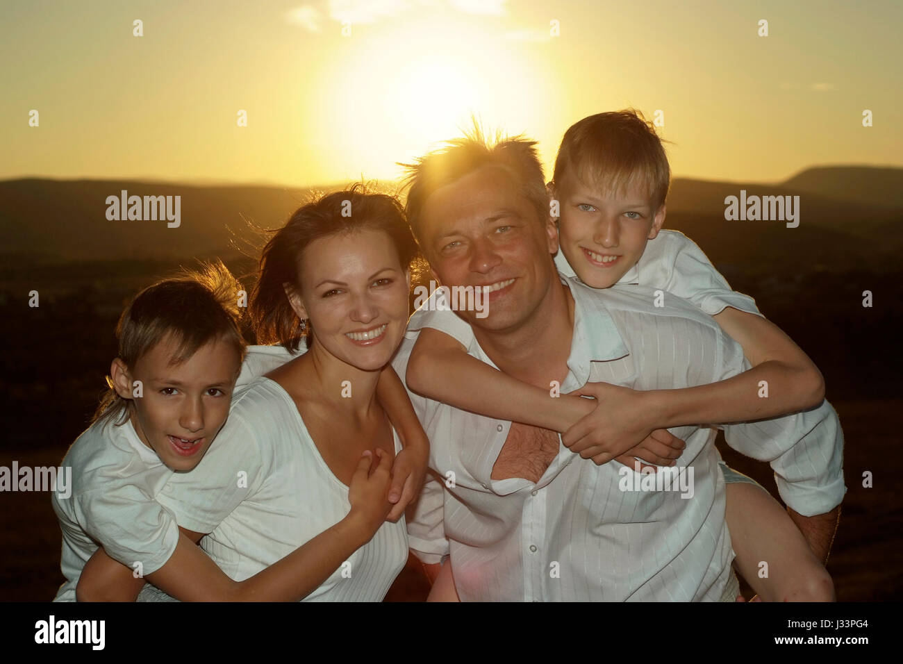 Happy child parents walk sunset hi-res stock photography and images - Alamy