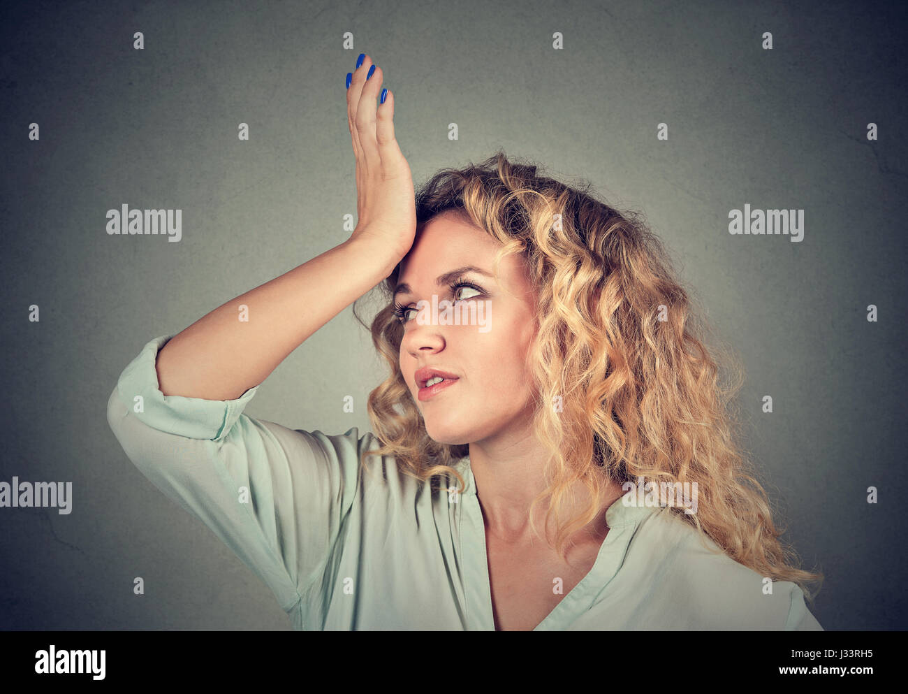 Regrets wrong doing. Closeup portrait silly young woman, slapping hand ...