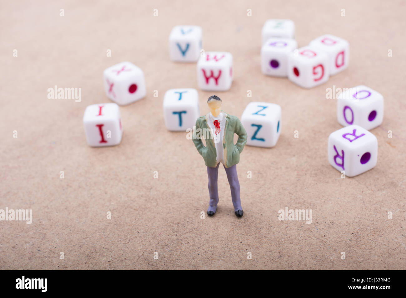 Figurine standing in front of the colorful alphabet letter cubes Stock ...